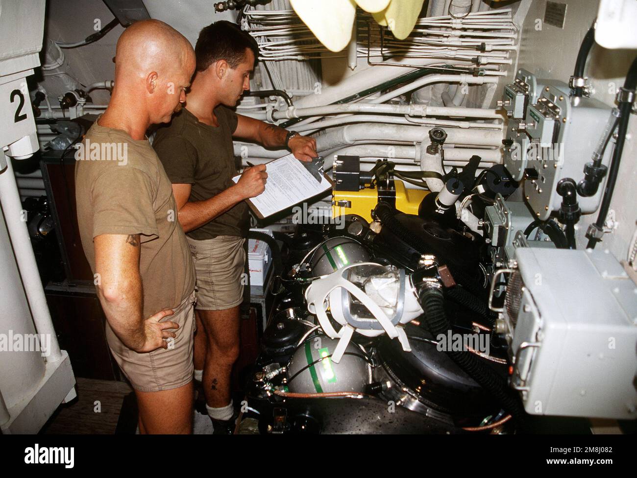 A Mark 15 UBA diving supervisor monitors a diver reviewing the Mark15 ...