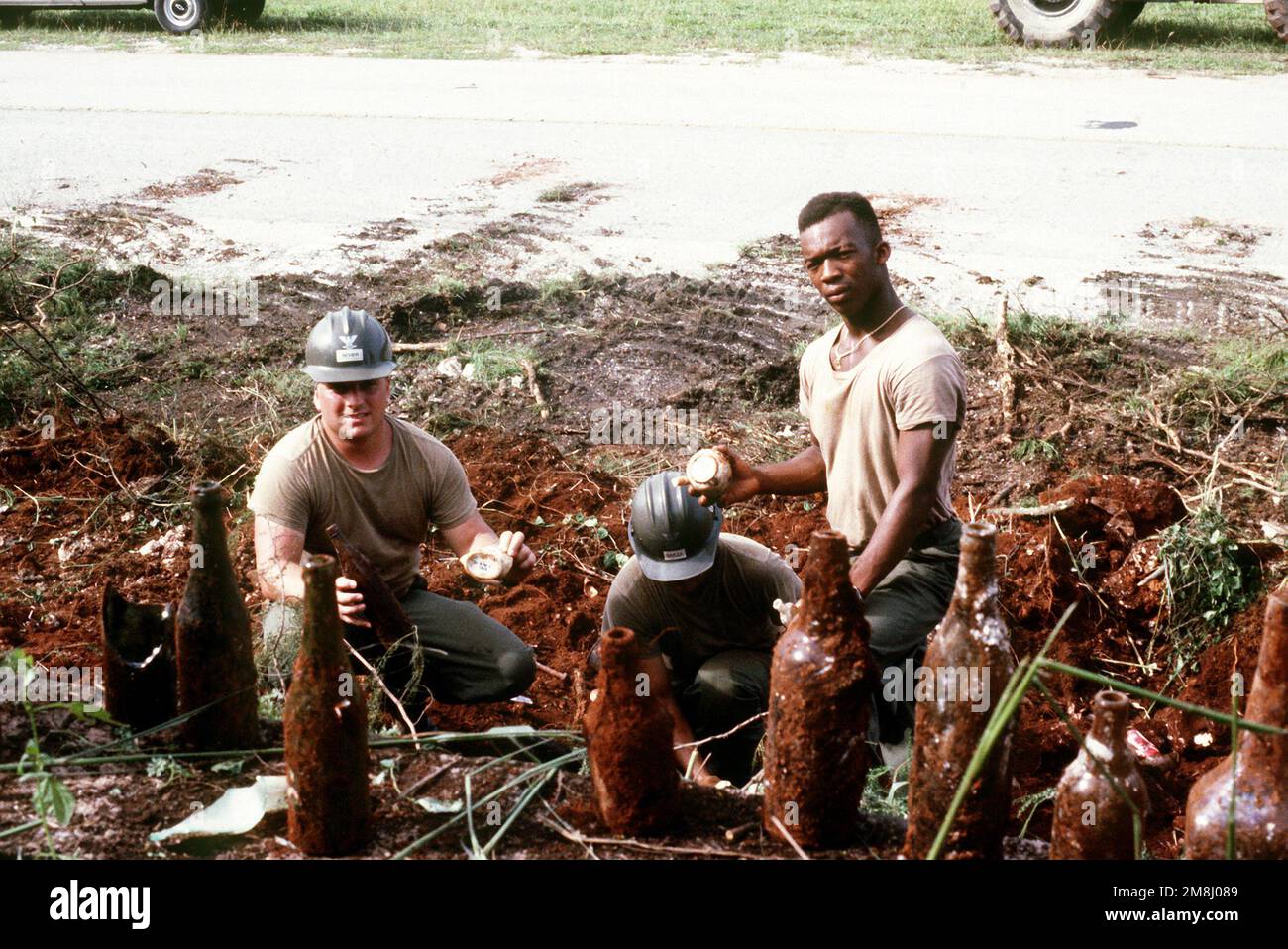 (Left to right) Builder Third Class (BU3) David Bevier, MASTER at Arms ...