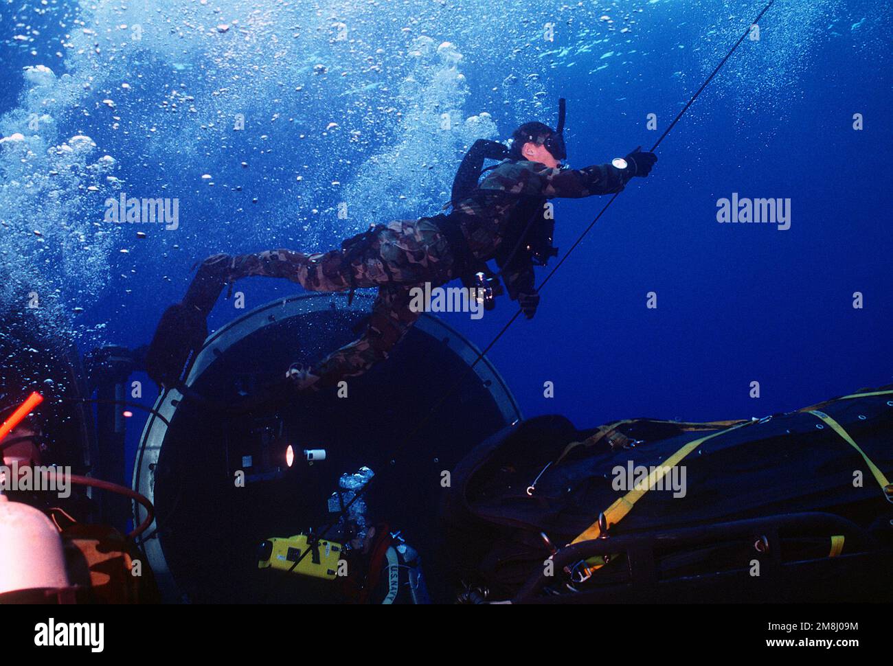 A SEAL Swimmer ascends from the nuclear-powered submarine USS ...