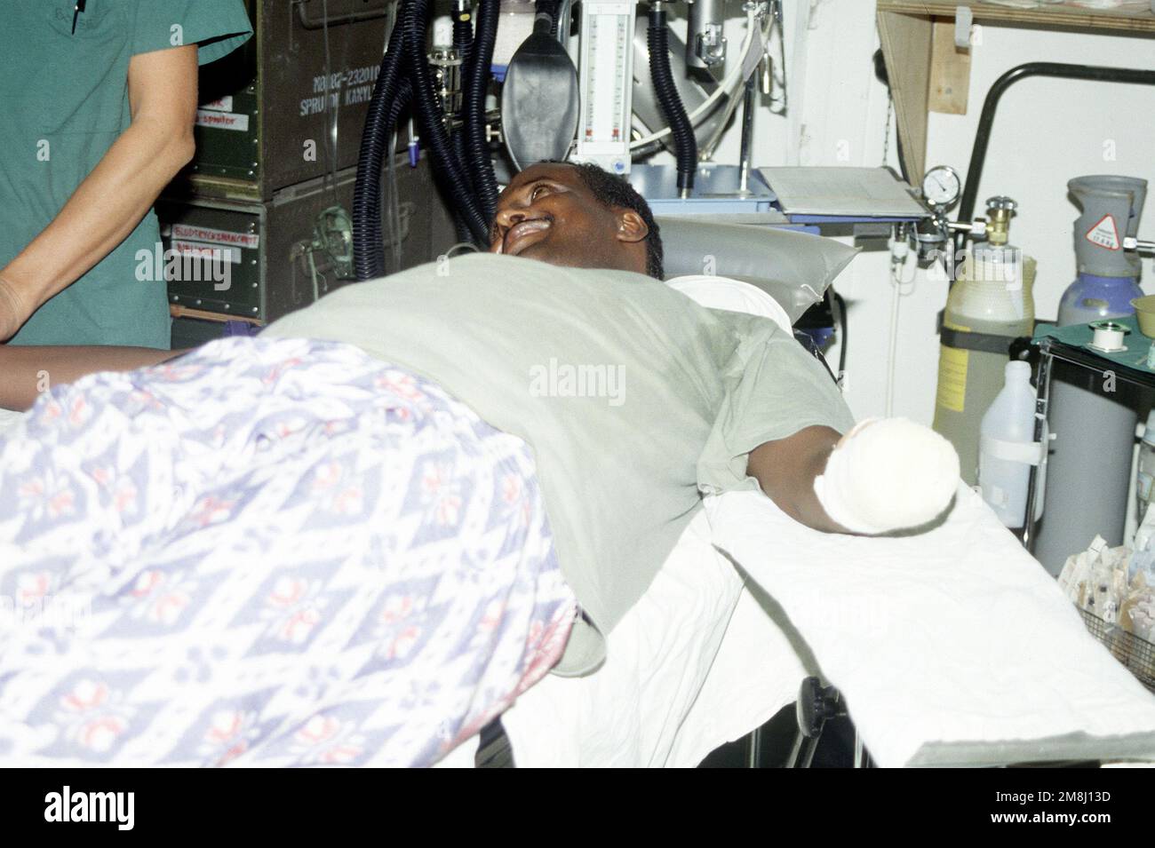 Abdi Ahmed Elmi has bandages changed on left arm after his hand was ...