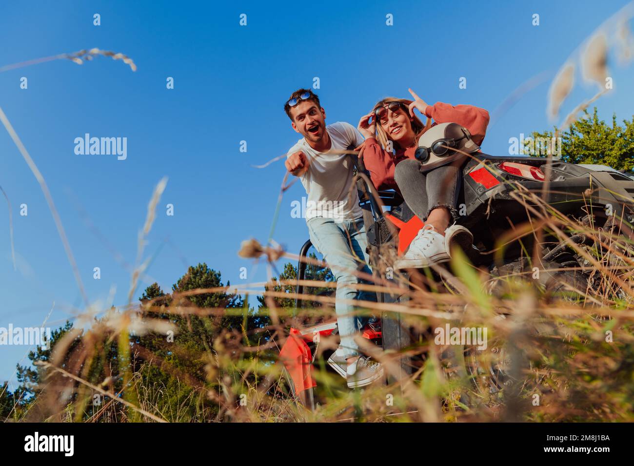 Young happy excited couple enjoying beautiful sunny day while driving a ...