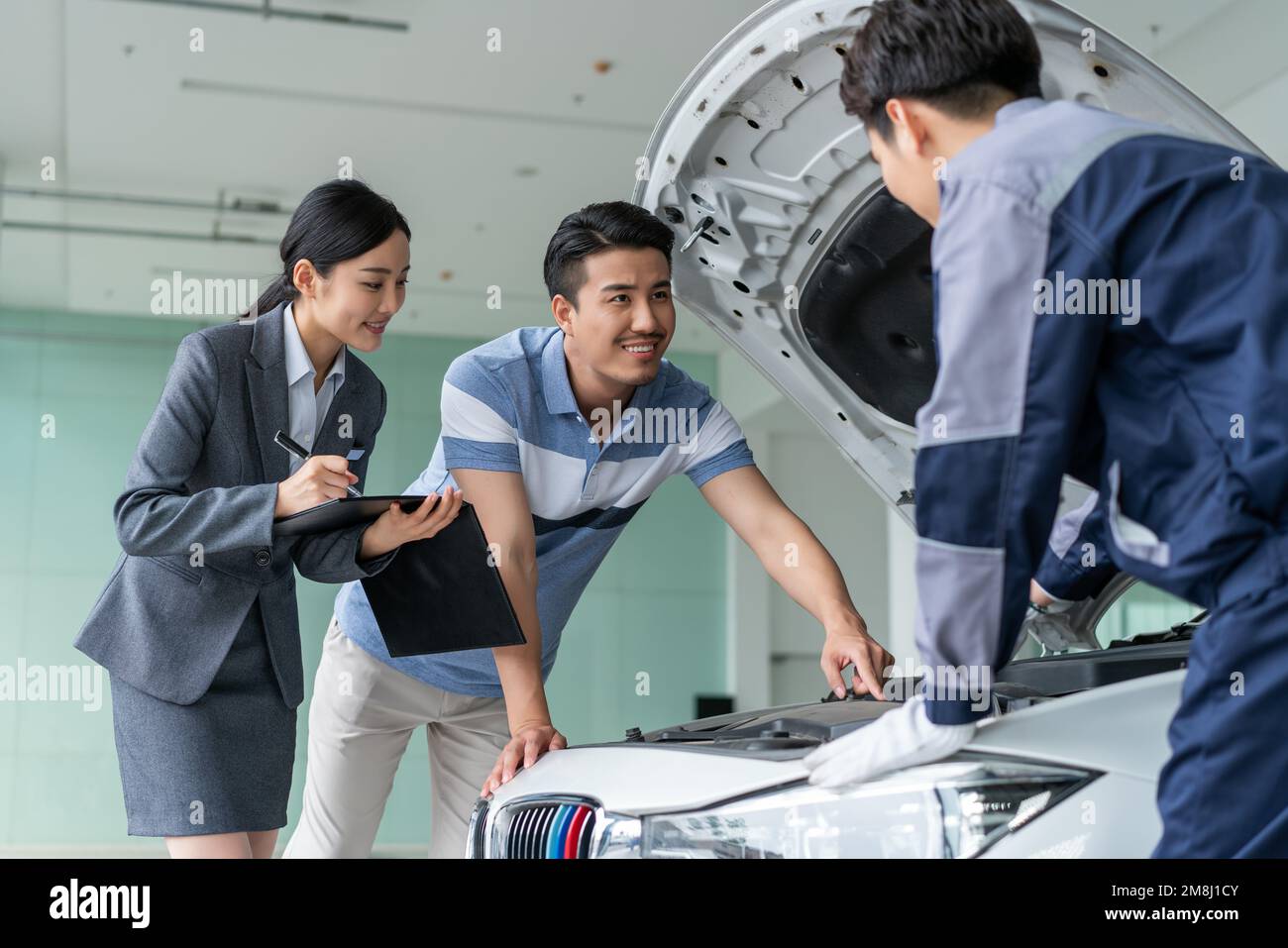 Repair shop mechanics of personnel with the customer Stock Photo - Alamy