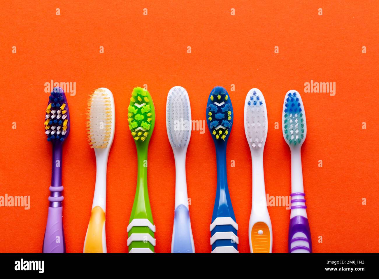 Toothbrushes on a orange background. Concept toothbrush selection. Oral ...