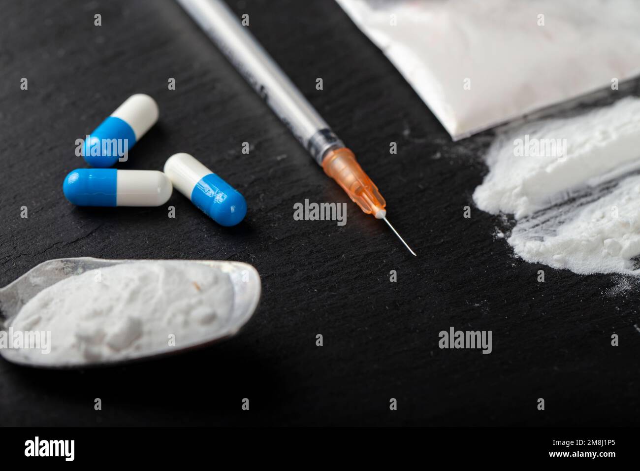 Substance abuse. Hard drugs on dark table. Drug syringe Stock Photo - Alamy