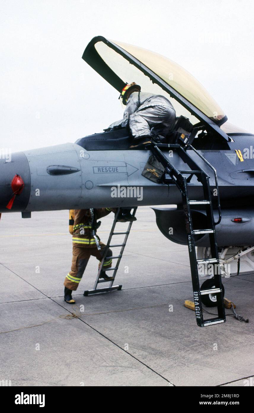 STAFF SGT. Rowe (in silver) carefully lowers the pilot down out of his ...