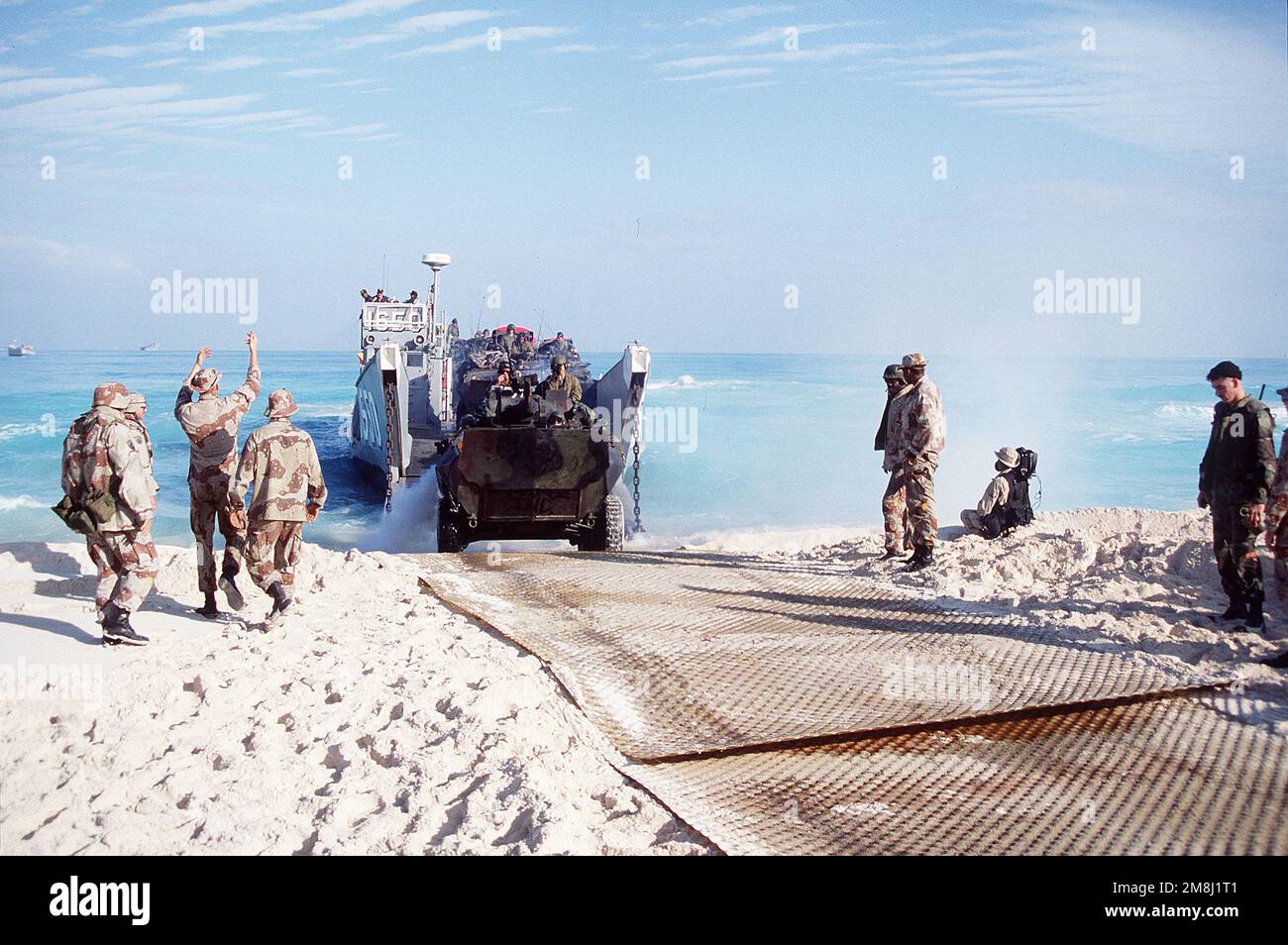 As a group of US Army soldiers watch, an LAV-25 light armored vehicle ...
