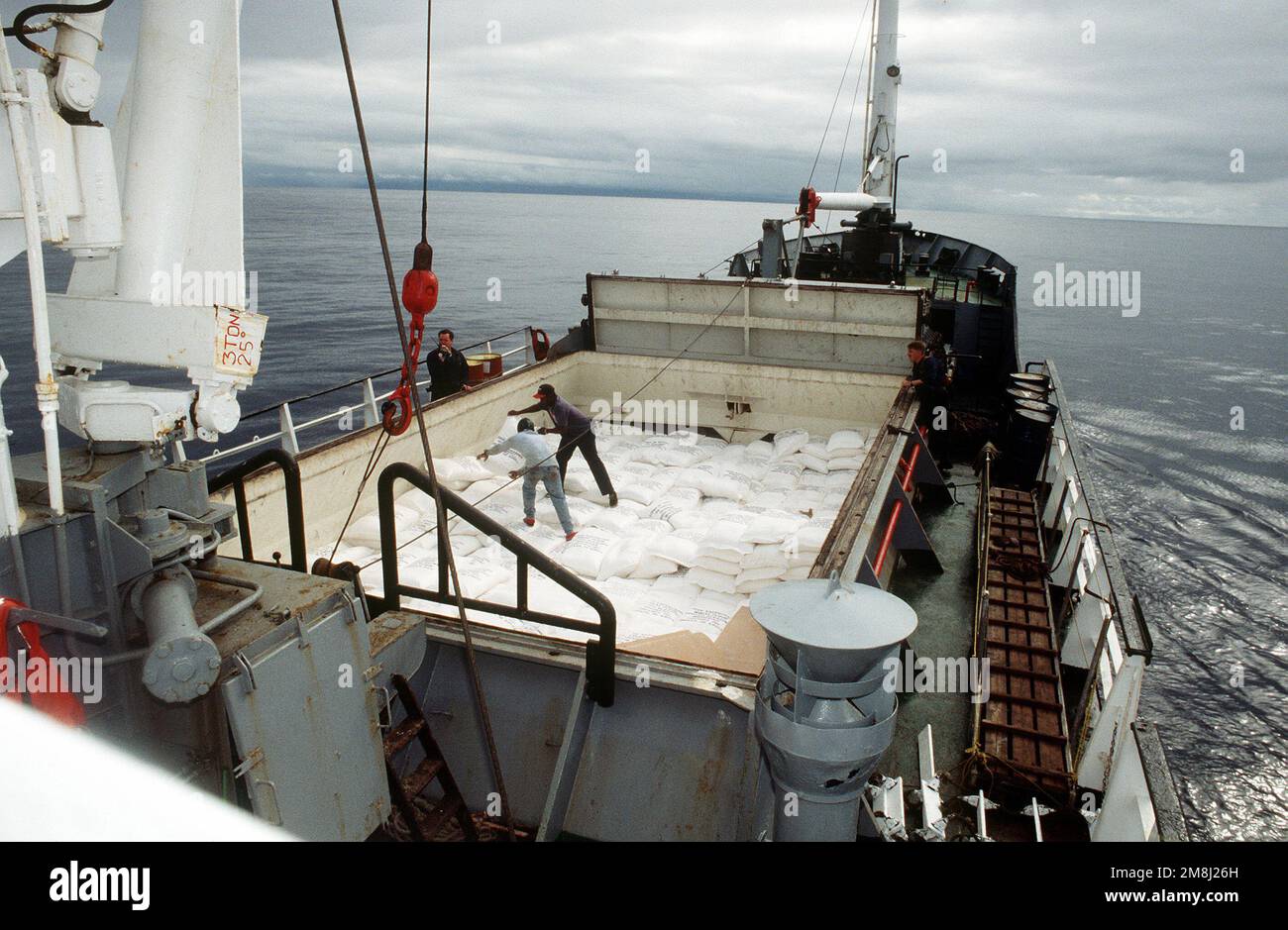 Crew members of the Haitian-bound merchant vessel BLACK EAGLE shift the ...