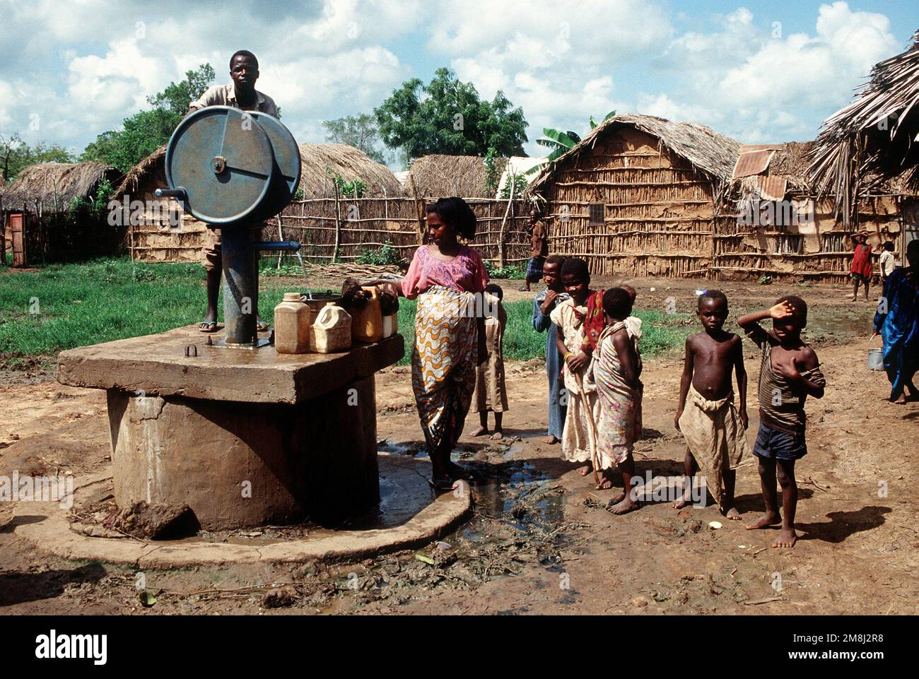 Local villagers use a water pump installed by a team of Belgian ...