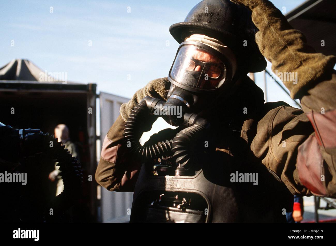 A student at Naval Fire Fighting School San Diego adjusts the face mask ...