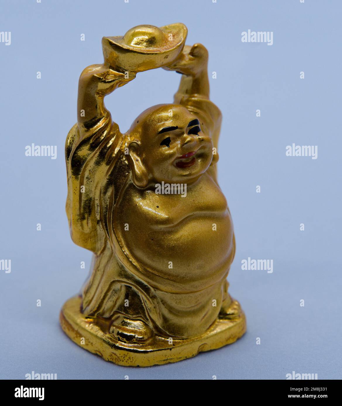 laughing budhdha statue golden color Stock Photo - Alamy