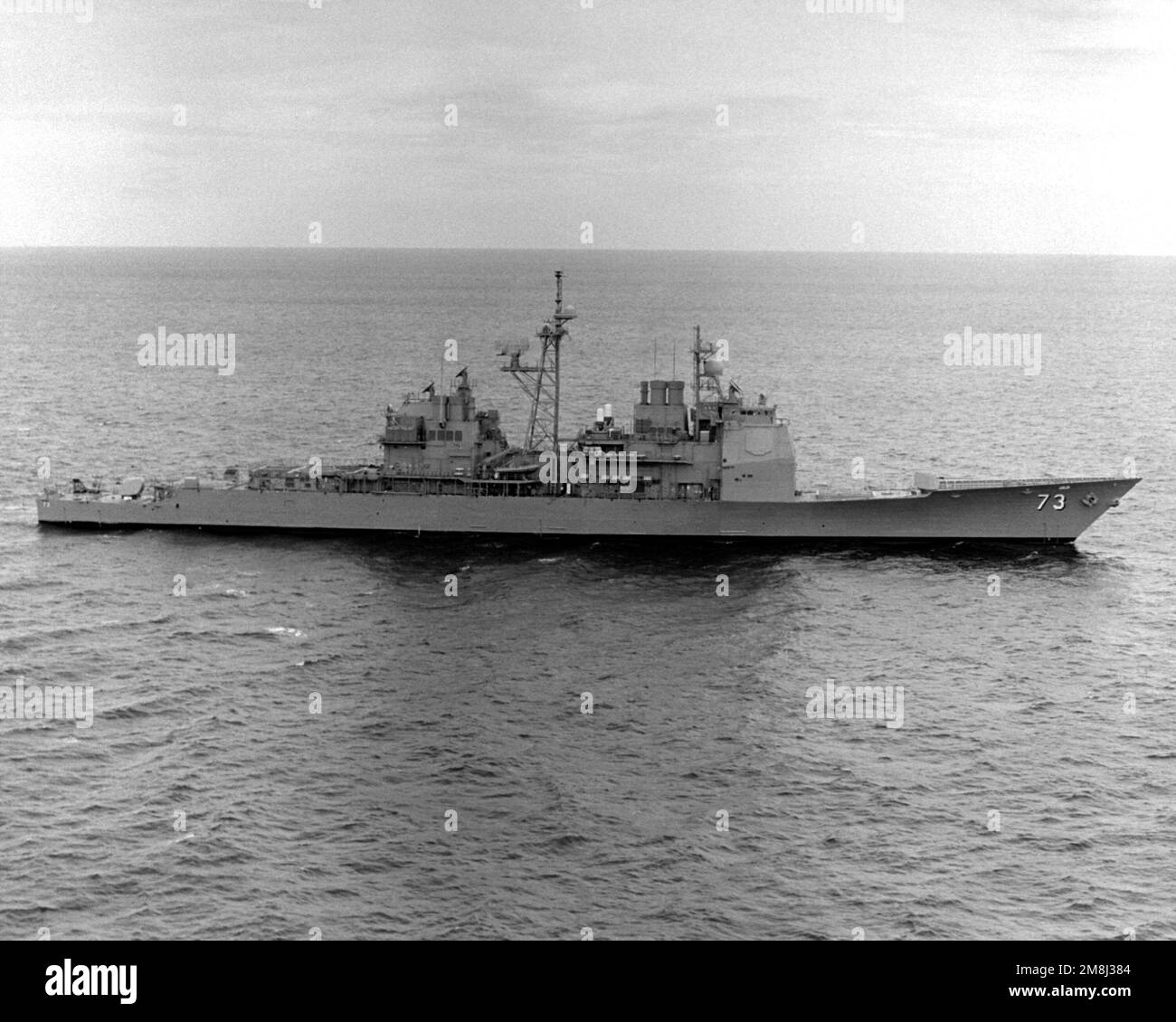 A low oblique starboard side view of the guided missile cruiser USS ...