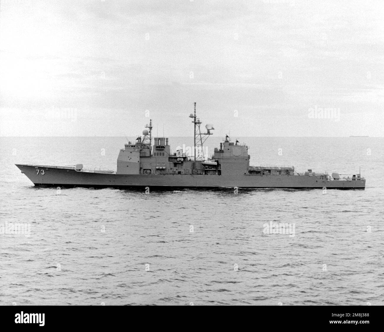 A low oblique port side view of the guided missile cruiser USS PORT ...
