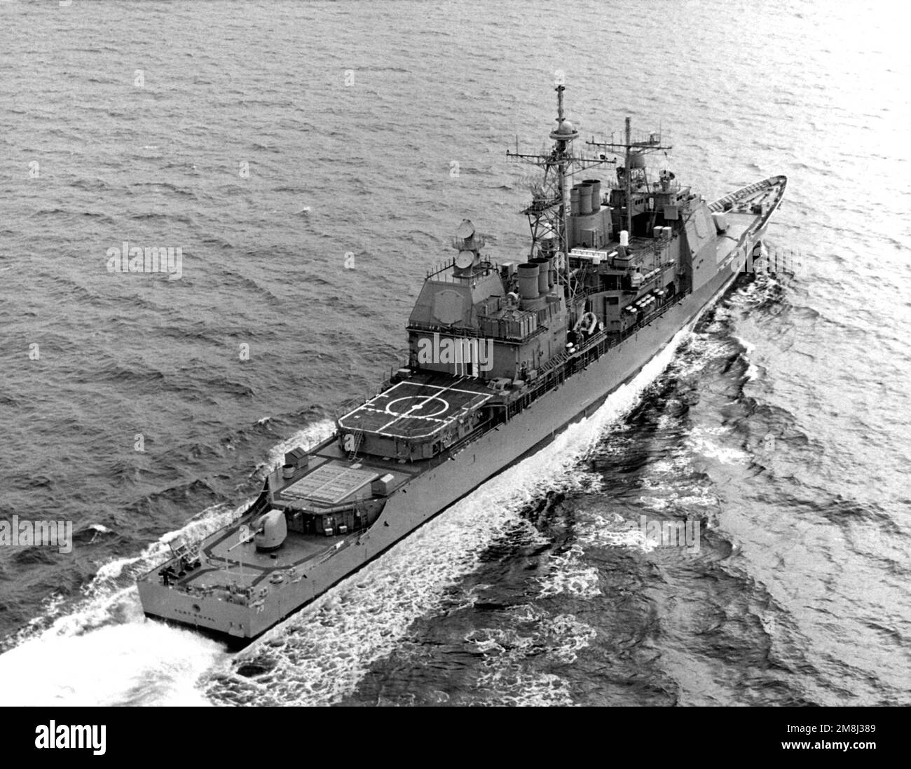 A high oblique starboard quarter view of the guided missile cruiser USS ...
