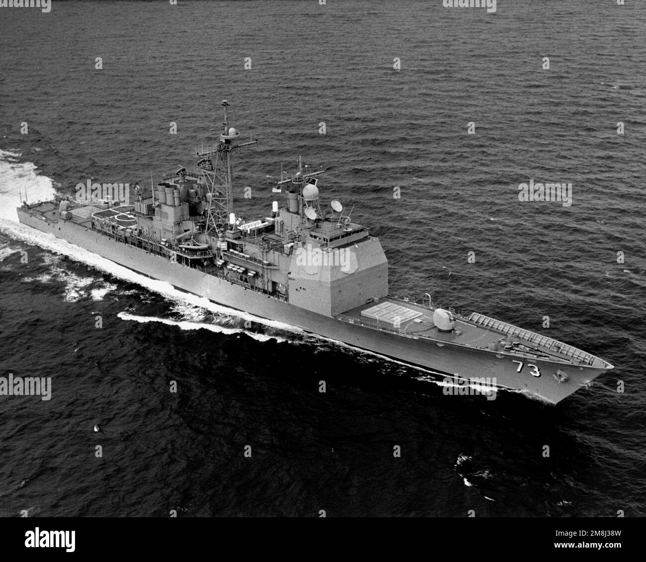 A high oblique starboard bow view of the guided missile cruiser USS ...