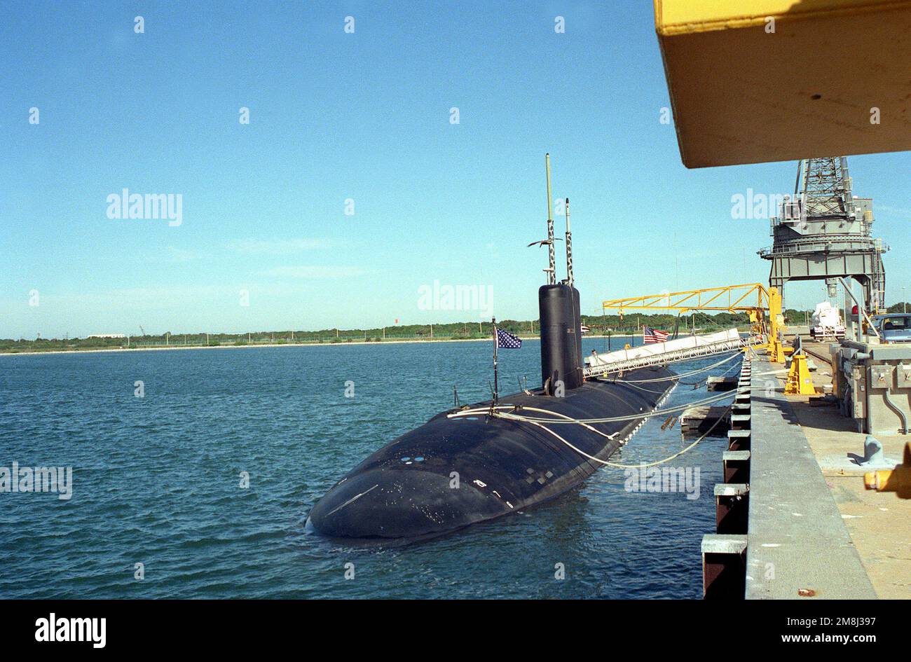 A port bow view of the nuclear-powered attack submarine USS HAMPTON ...