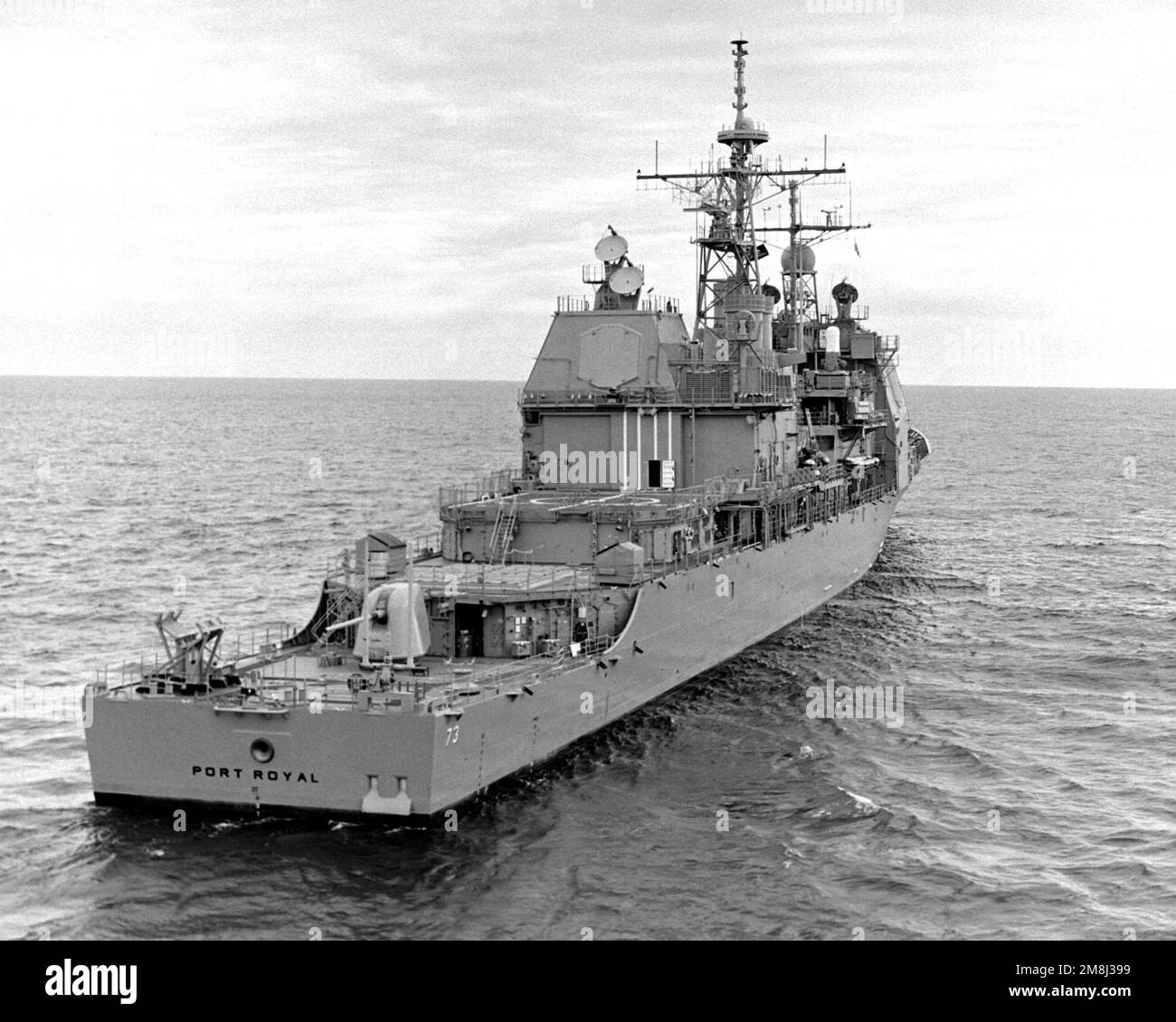 A low oblique starboard quarter view of the guided missile cruiser USS ...
