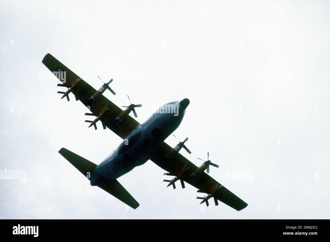 A C-130 Hercules aircraft with four firebee target drones hung under ...