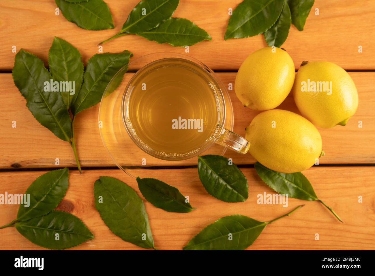 A cup of green tea, tea leaves and lemons,top view Stock Photo - Alamy