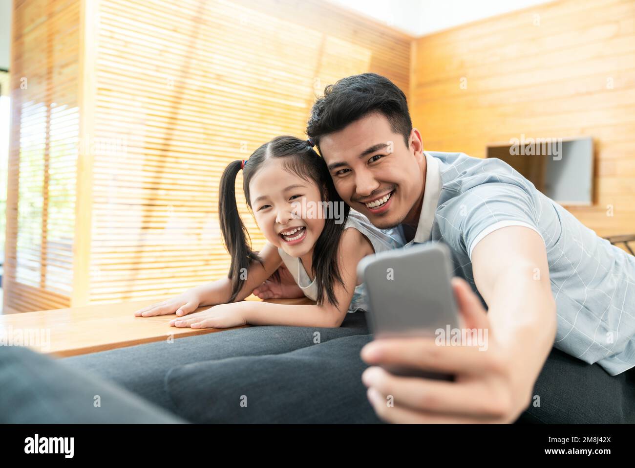Happy father sitting on the sofa Stock Photo - Alamy