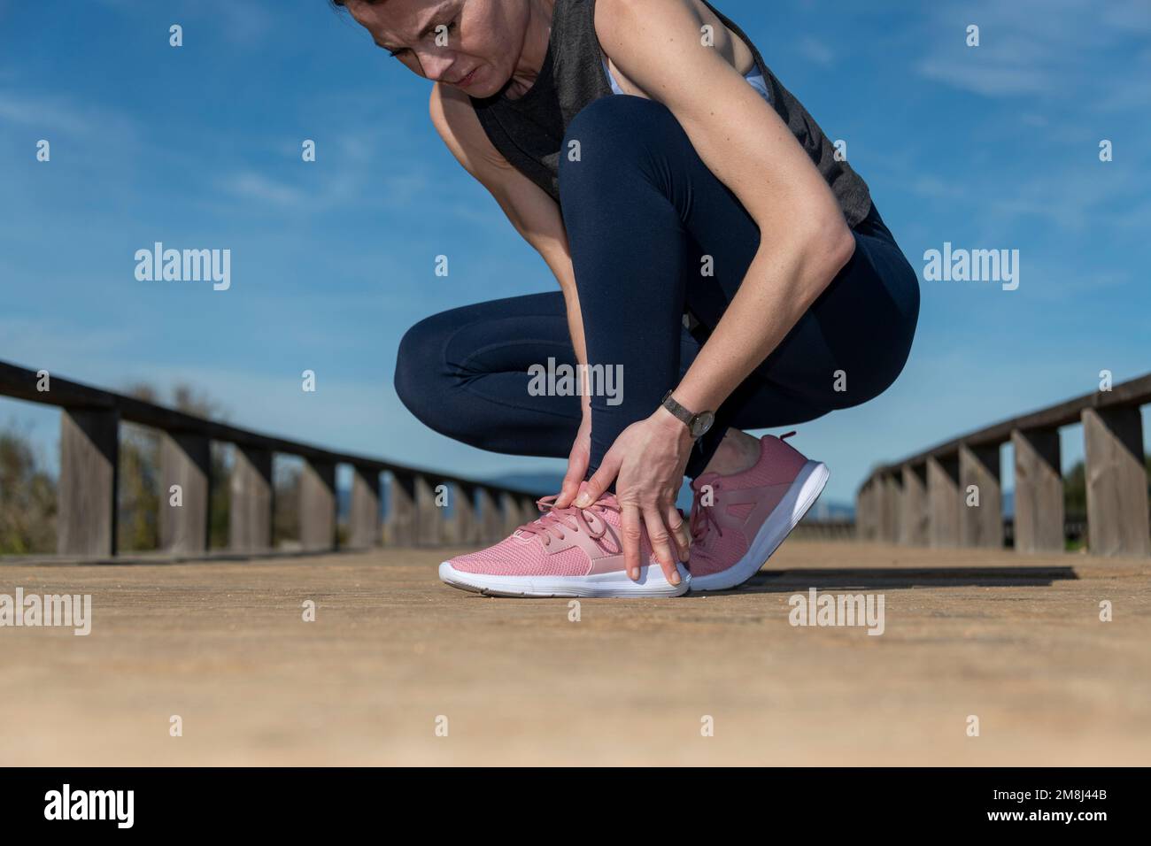 Painful running injury. Detail of runner holding her ankle Stock Photo ...