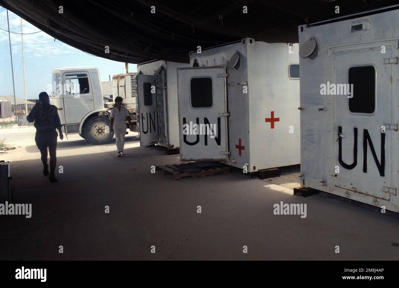 Tarpaulins shade the entrance to the United Nations field hospital run ...