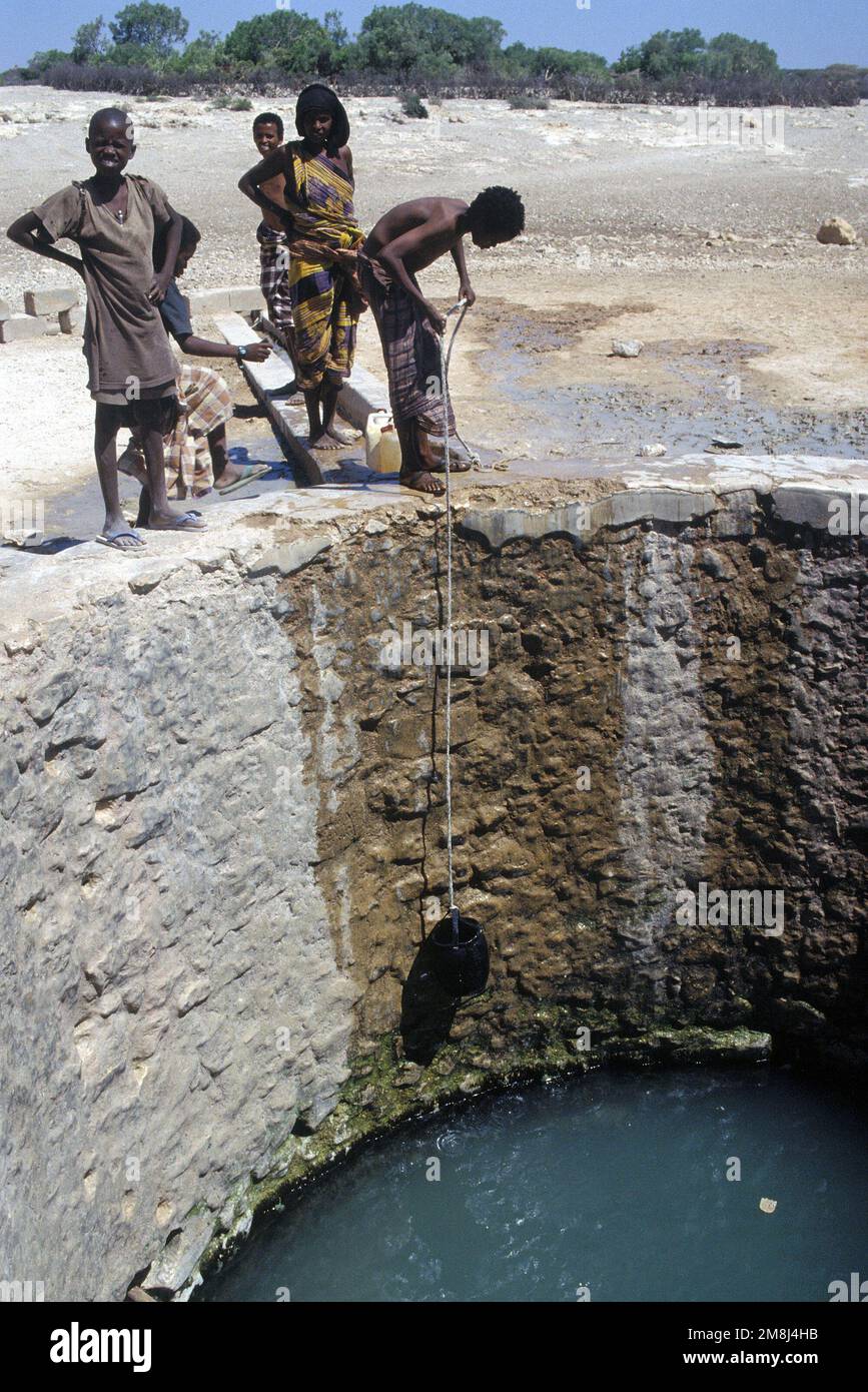 Somalis draw from an open well. Waajid is alos the location of a water ...