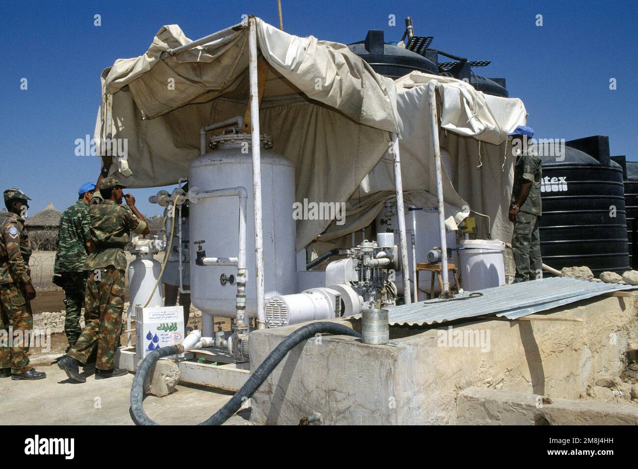 Hellenic and Indian Soldiers tour the water purification plant. The ...