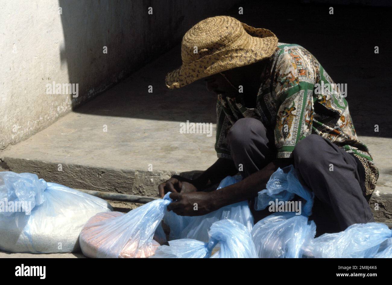 A Somali resident examines the contents of a food bag given to him by ...