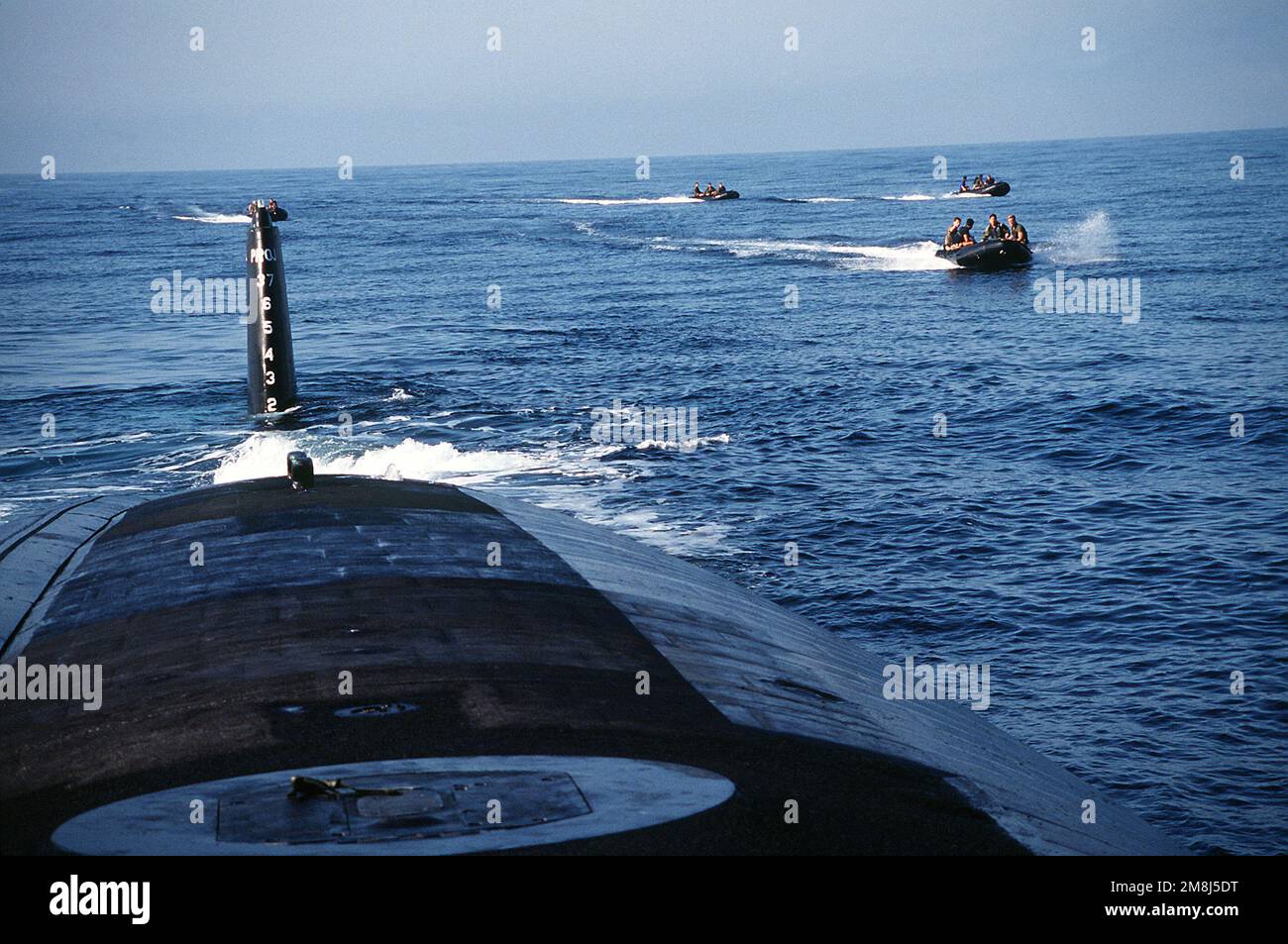 Four Zodiac boats carrying members of SEAL Team One are shown racing to ...