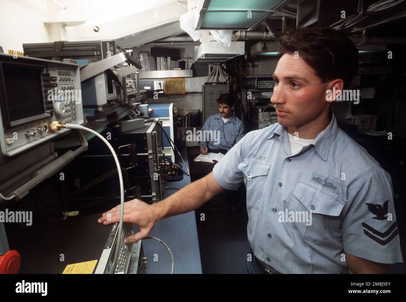 Electronics Technician Second Class (ET2) Chris Spencer checks spurious ...