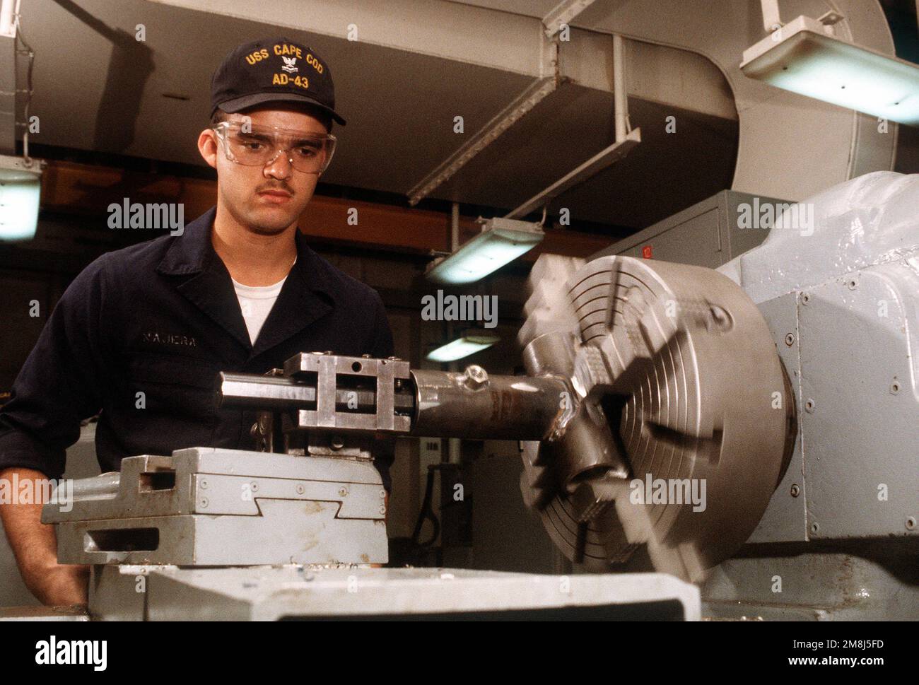 Machine Repairman Second Class (MM2) Jesus Gallard expands the inside ...