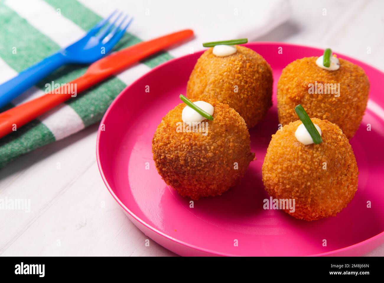 Sobrasada and brie croquettes. Portion of dough made from a dense sauce ...