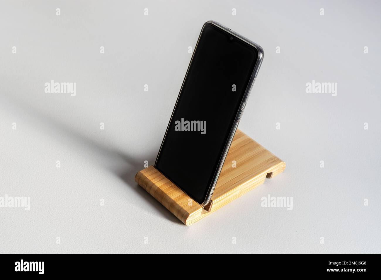 Mobile phone mounted on a special stand on a white background Stock ...