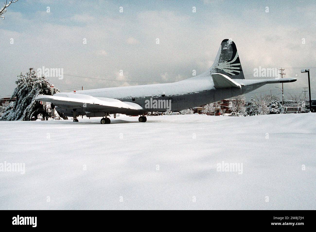 A snow covered P-3C Orion aircraft of Patrol Wing Five, Patrol Squadron ...