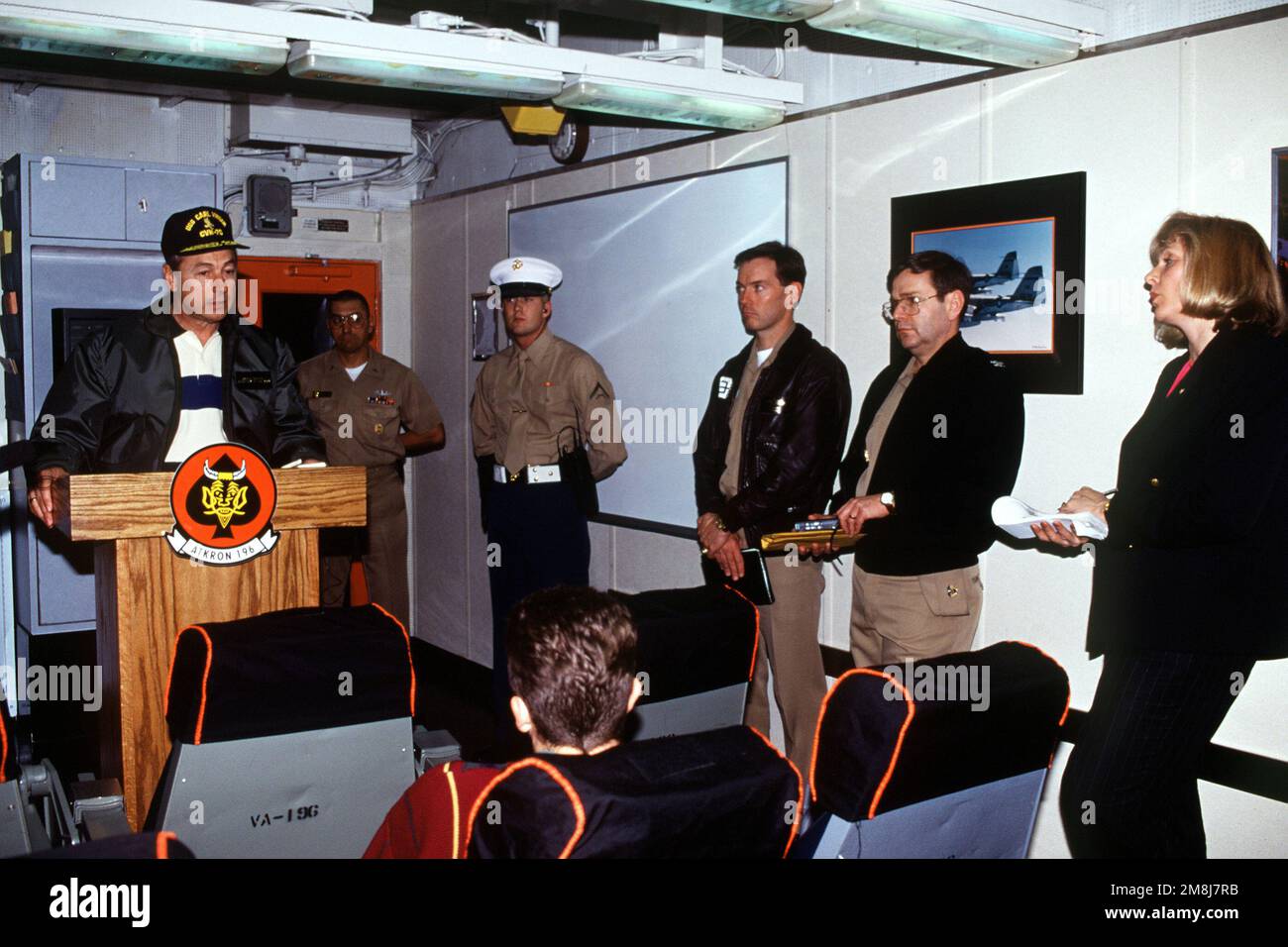 During a recent visit, Secretary of the Navy John H. Dalton holds a ...
