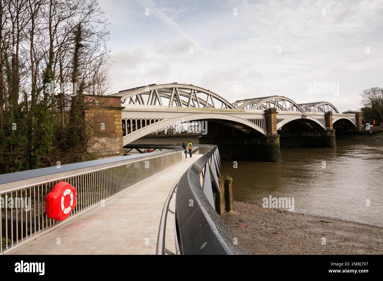 The Barnes Bridge Walkway next to the River Thames and under Barnes ...