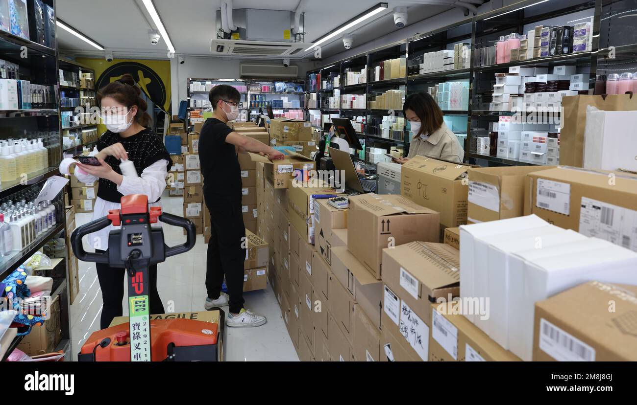 Employees arrange products at a shop in Sheung Shui. Hong Kong will ...