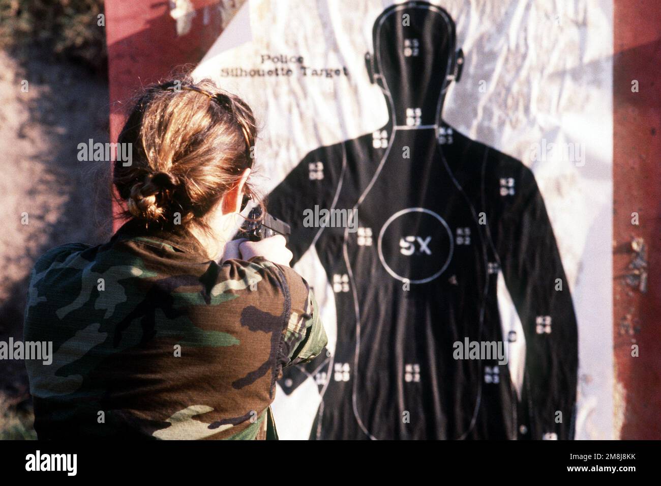 Photographers Mate Second Class (PH2) Erin Waters fires a .38 caliber ...