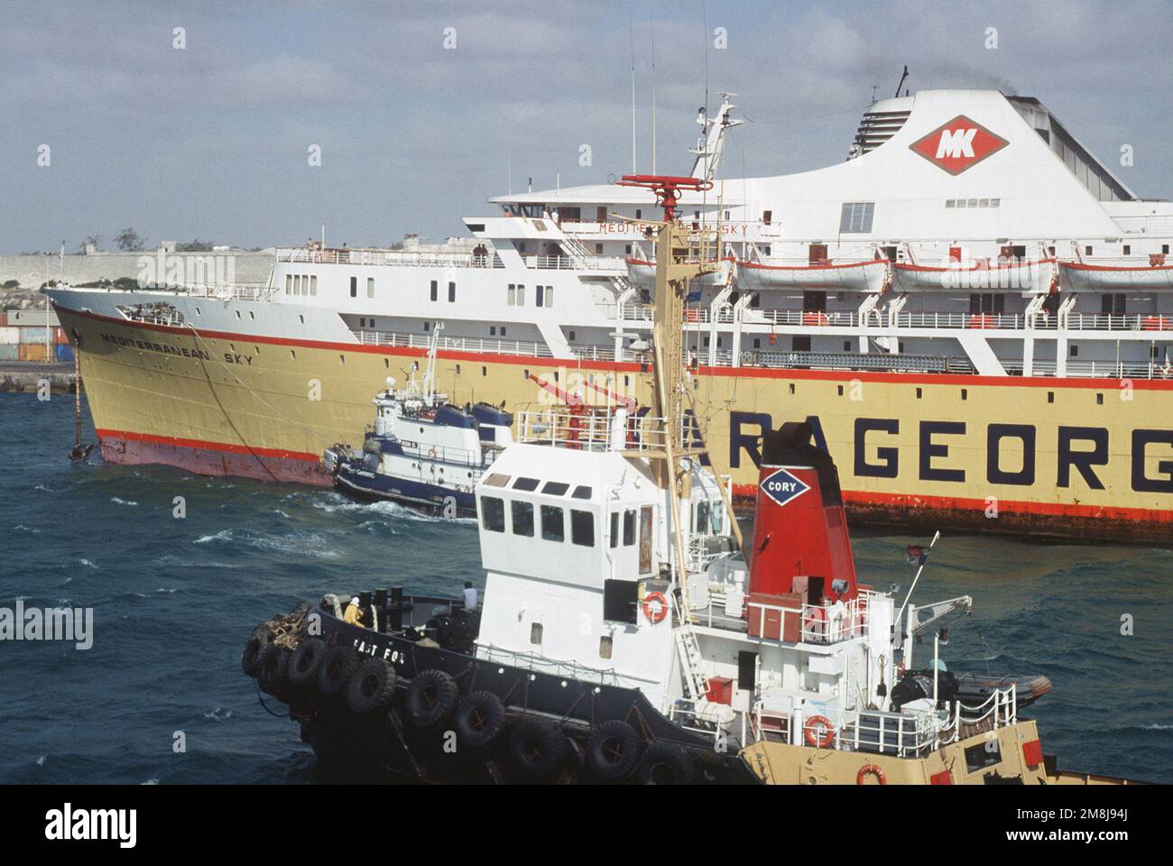 A commercial tugboat guides the Military Sealift Command chartered ...