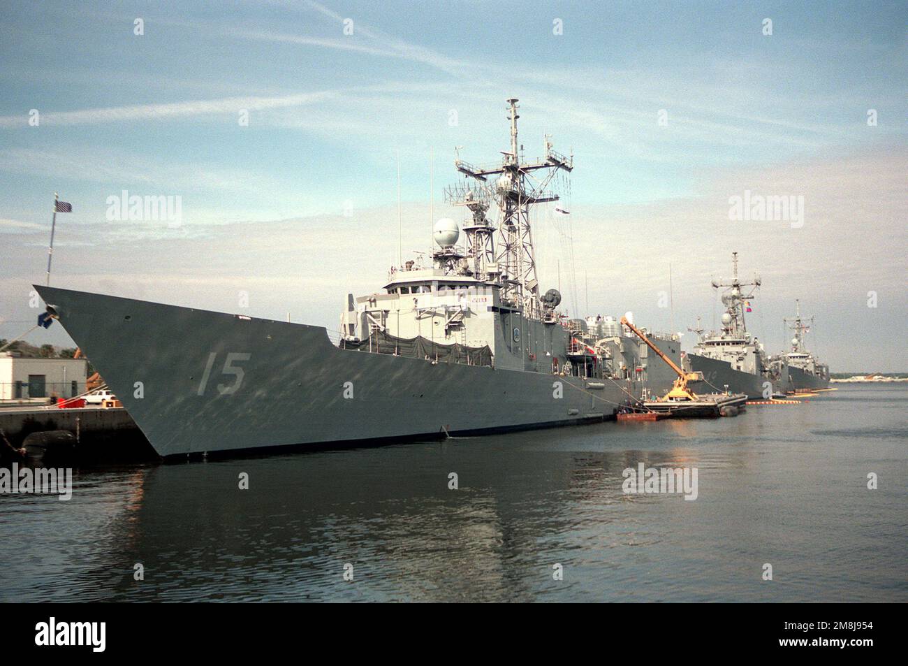 A port bow view of the guided missile frigate USS ESTOCIN (FFG-15) tied ...