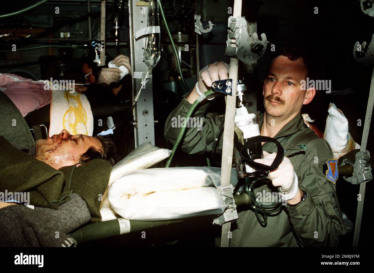 Members from the 2nd Aero Medical Squadron place the wounded patient on ...