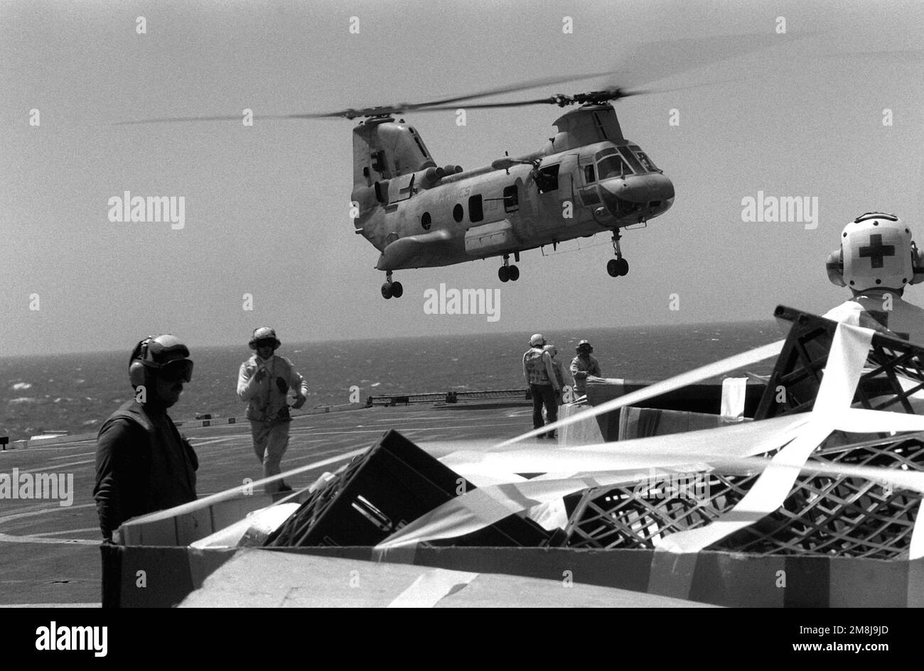 A Marine Corps CH-46 Sea Knight helicopter prepares to land aboard the ...