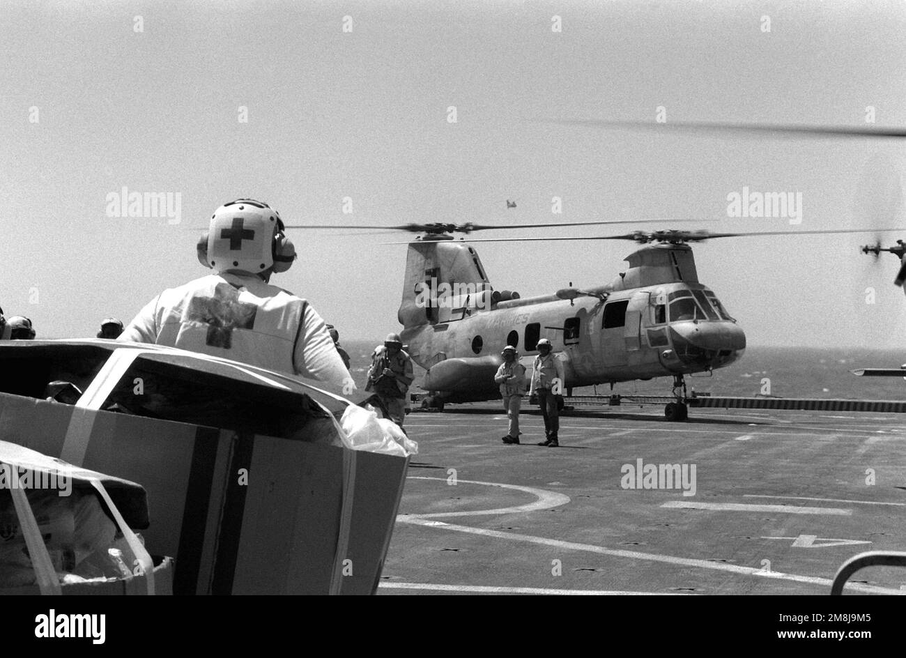 A Marine Corps CH-46 Sea Knight helicopter lands aboard the amphibious ...