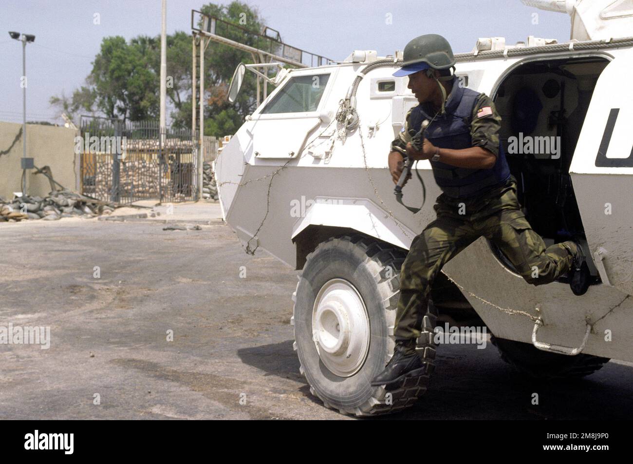 A Melanesian soldier leaps out of an armored personnel carrier in ...