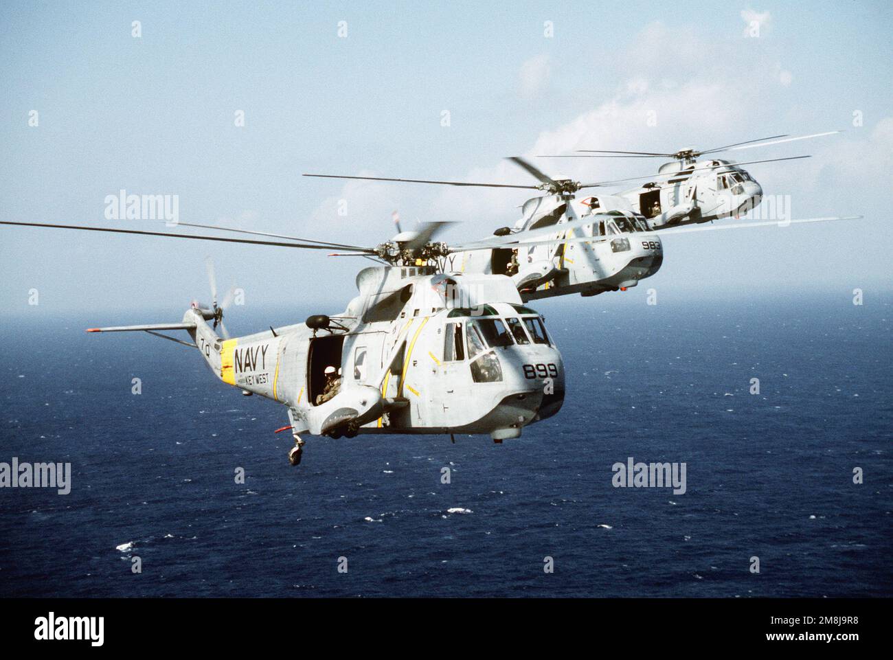 Three helicopters flying in formation hi-res stock photography and ...