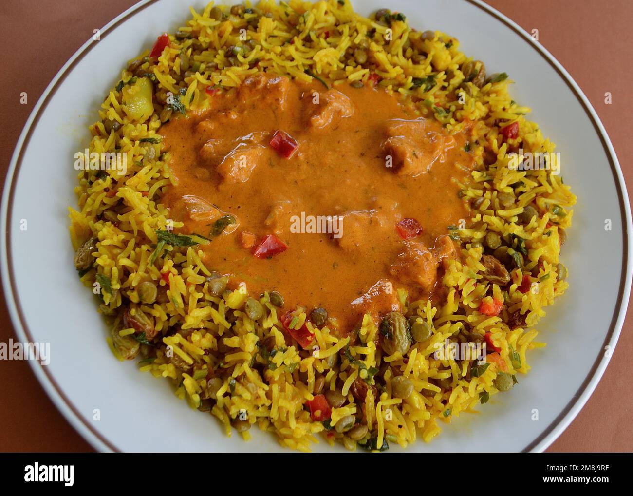 Delicious butter chicken with basmati saffron rice and lentils Stock ...