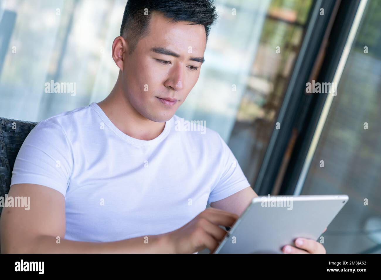 The young man use tablets Stock Photo - Alamy