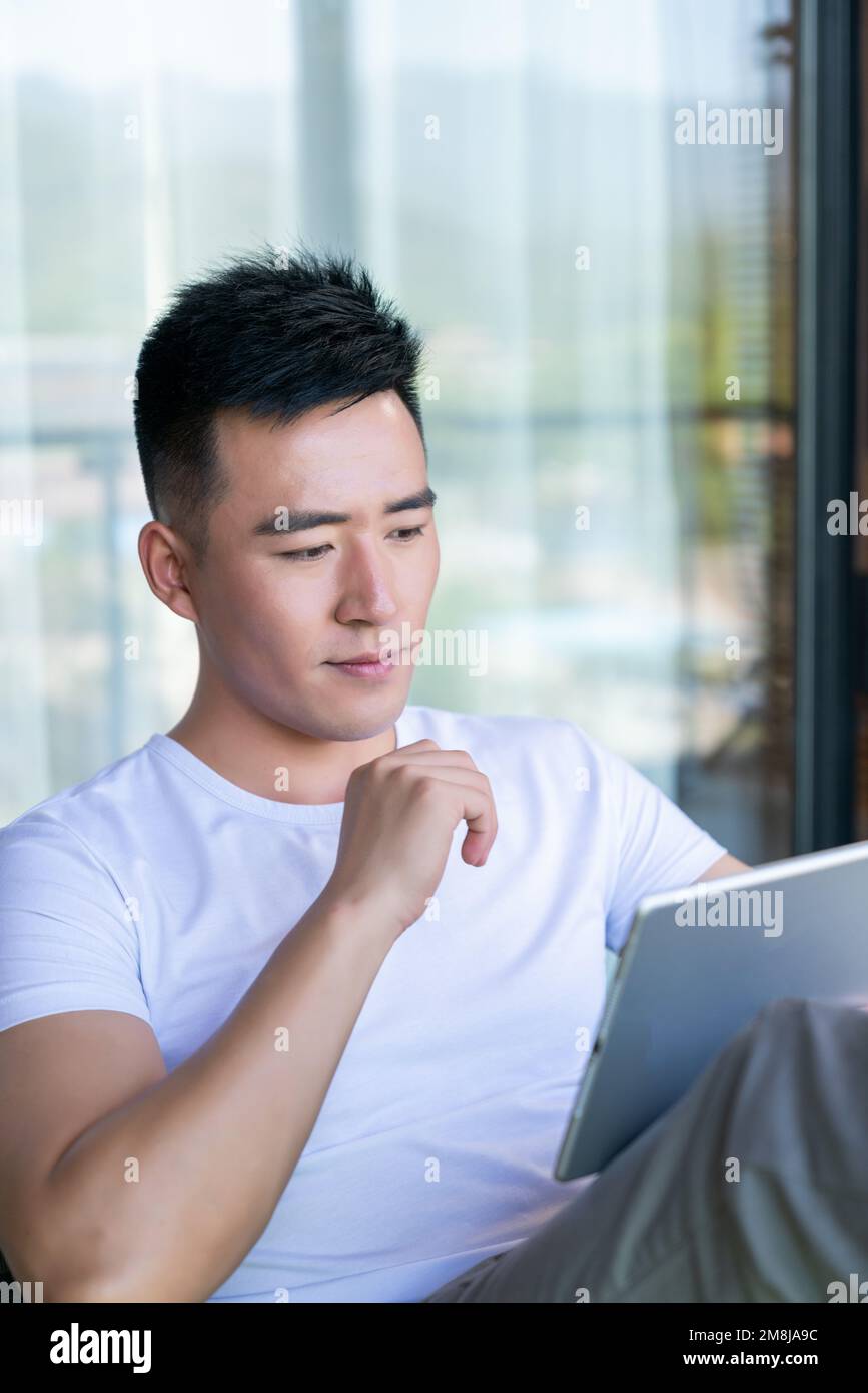The young man use tablets Stock Photo - Alamy