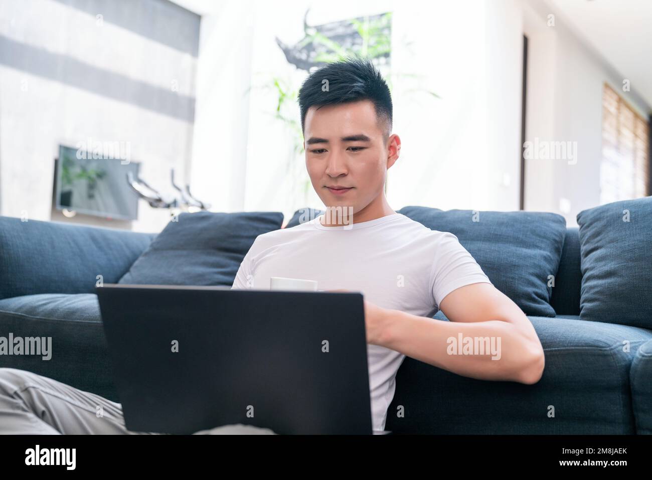 Young men who use a computer Stock Photo - Alamy