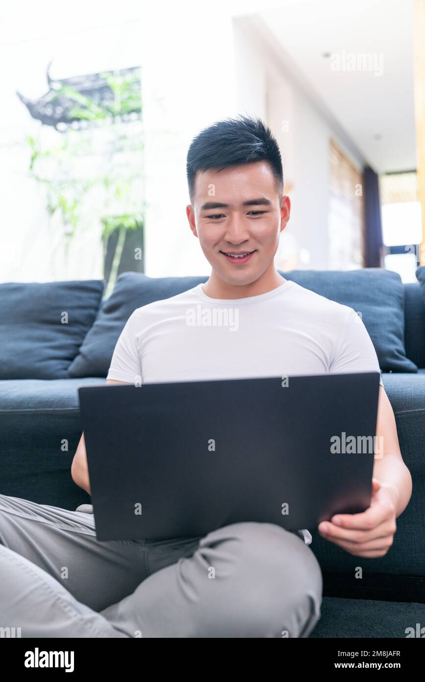 Young men who use a computer Stock Photo - Alamy